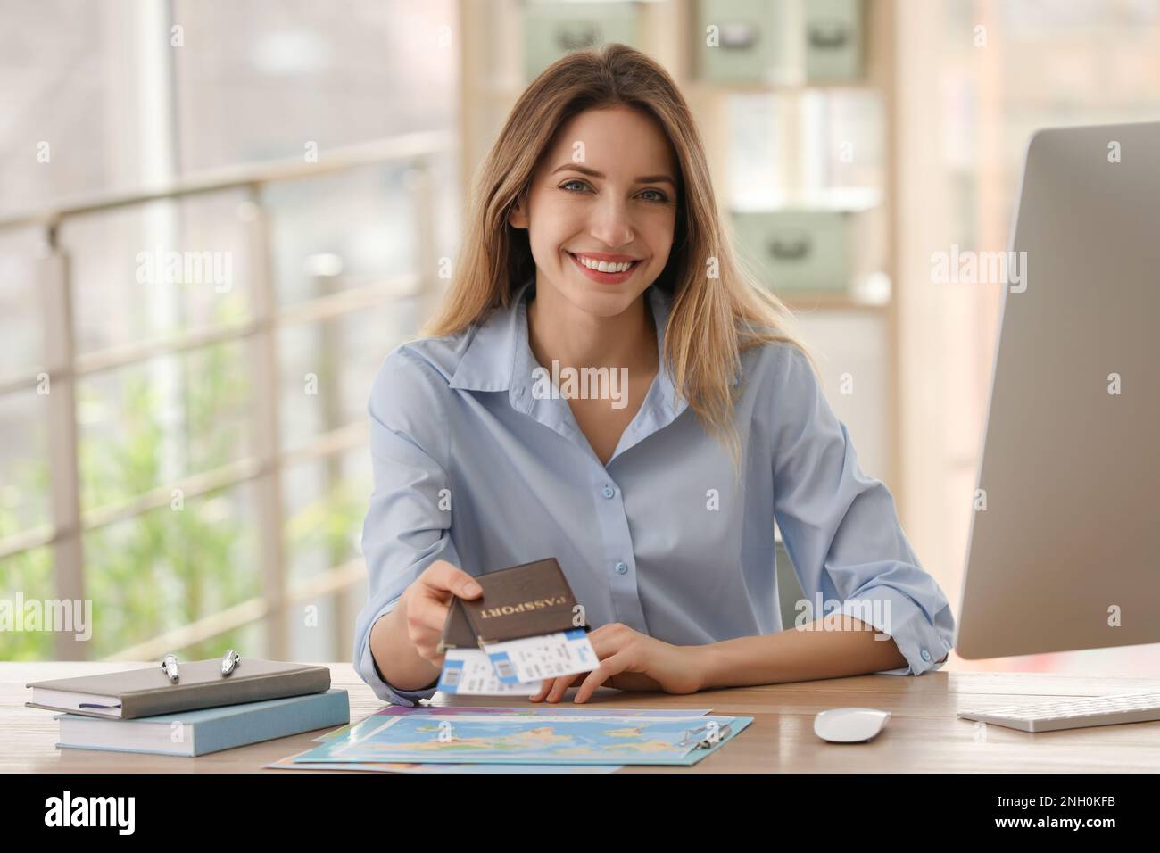 Travel agent with tickets and passports in office Stock Photo - Alamy
