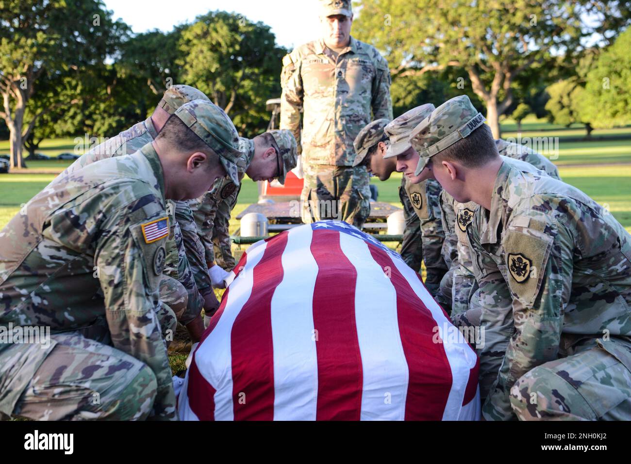 Defense POW/MIA Accounting Agency (DPAA) members drape the U.S. flag ...