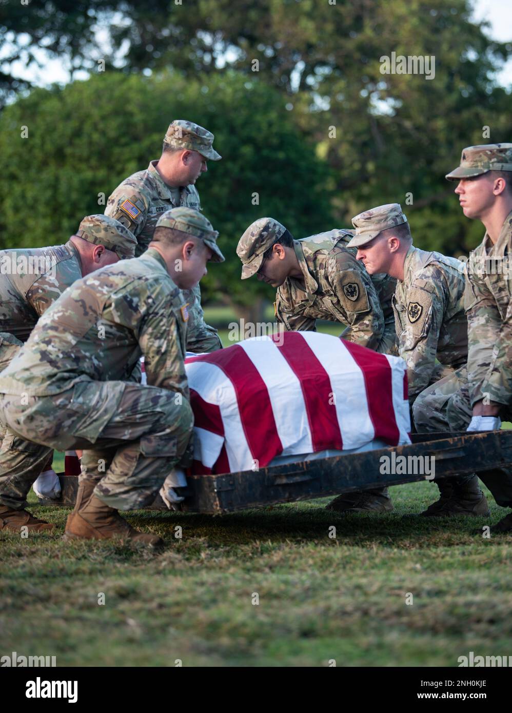 Defense POW/MIA Accounting Agency (DPAA) members pick-up a casket ...