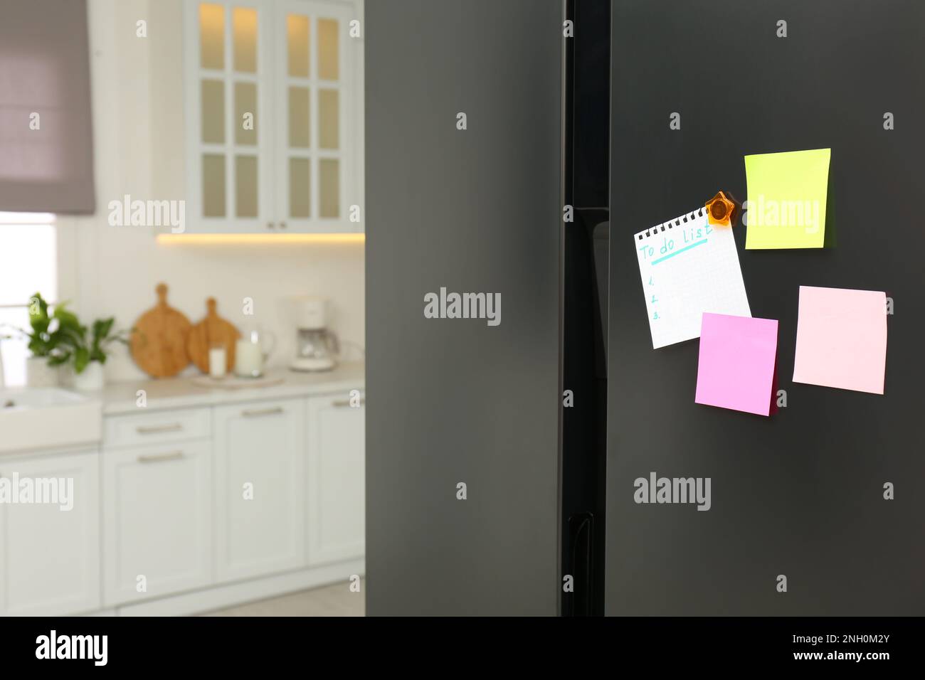 Blank To do list and sticky notes on fridge in kitchen. Space for text ...