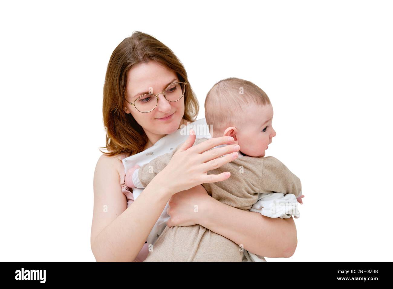 A mother woman holds an infant baby to regurgitate excess air after ...