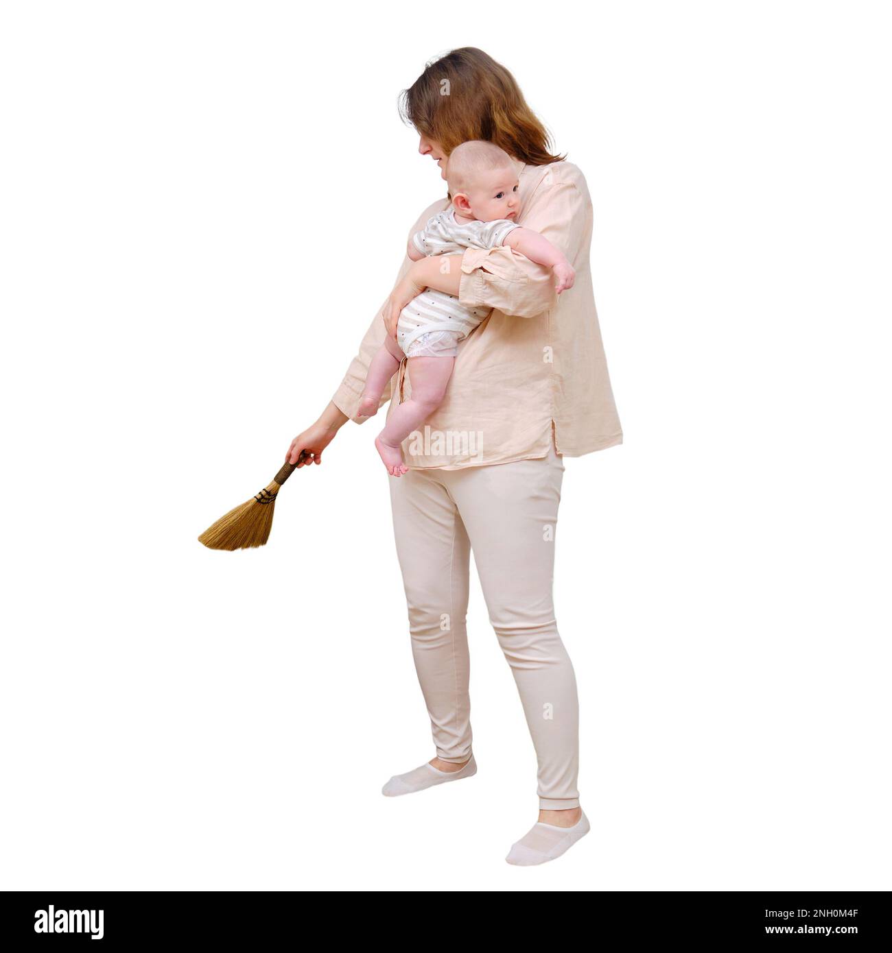 Woman cleans the home living room with an infant baby in her arms ...