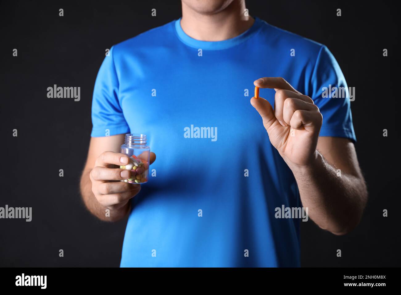 Man with pills on black background, closeup. Doping concept Stock Photo ...