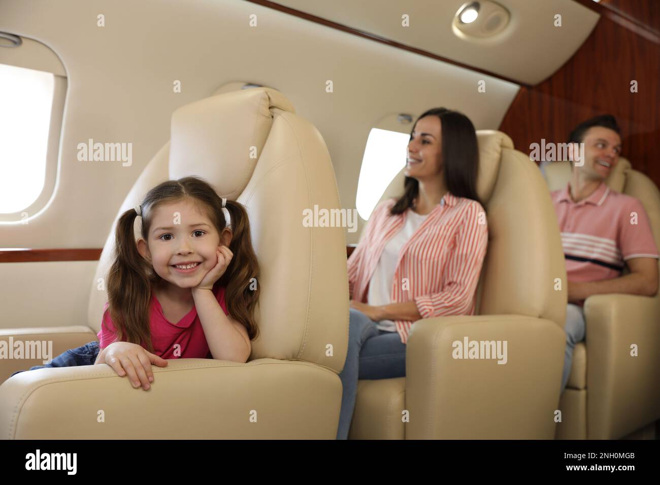 Happy family together in airplane during flight Stock Photo - Alamy