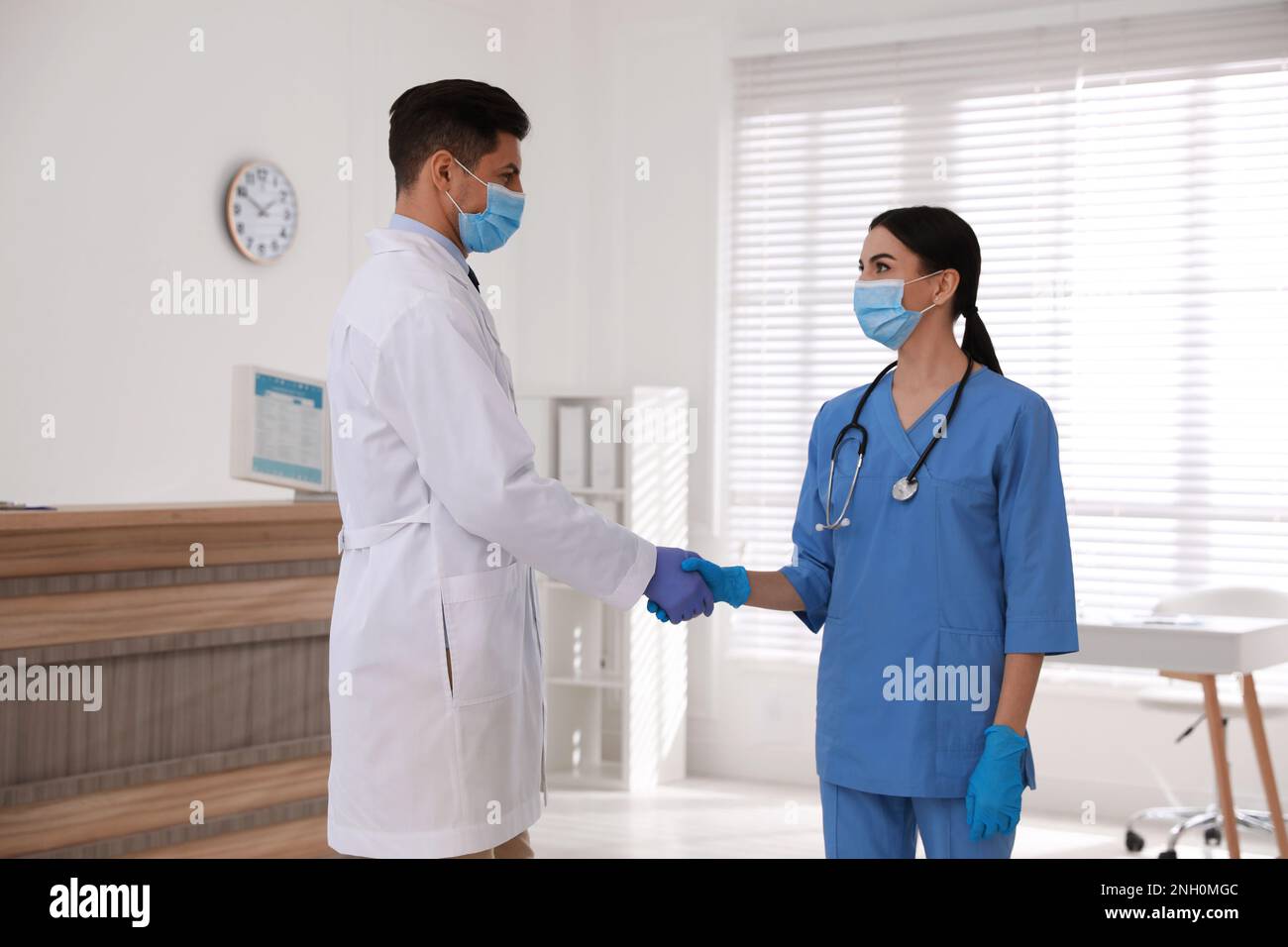 Surgical gloves handshake hi-res stock photography and images - Alamy