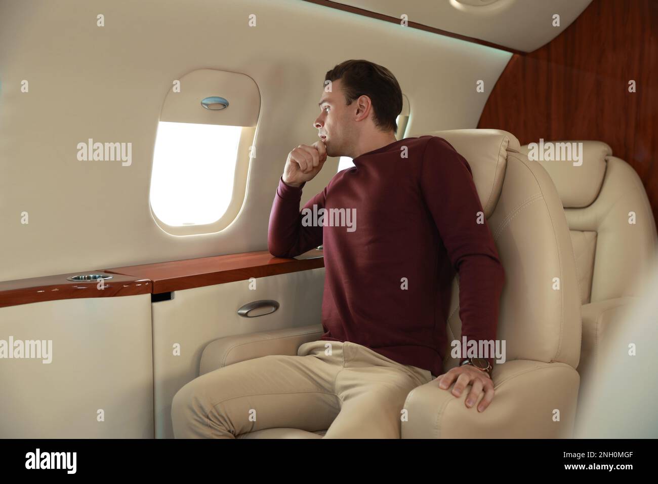 Nervous young man in airplane. Aviophobia concept Stock Photo - Alamy