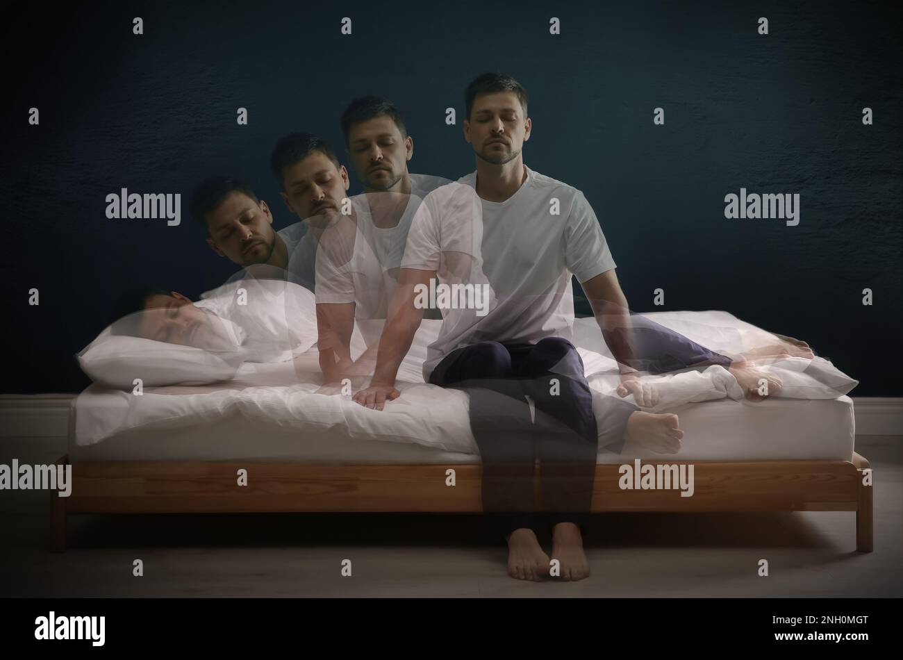 Somnambulist rising from bed near dark wall indoors, multiple exposure ...