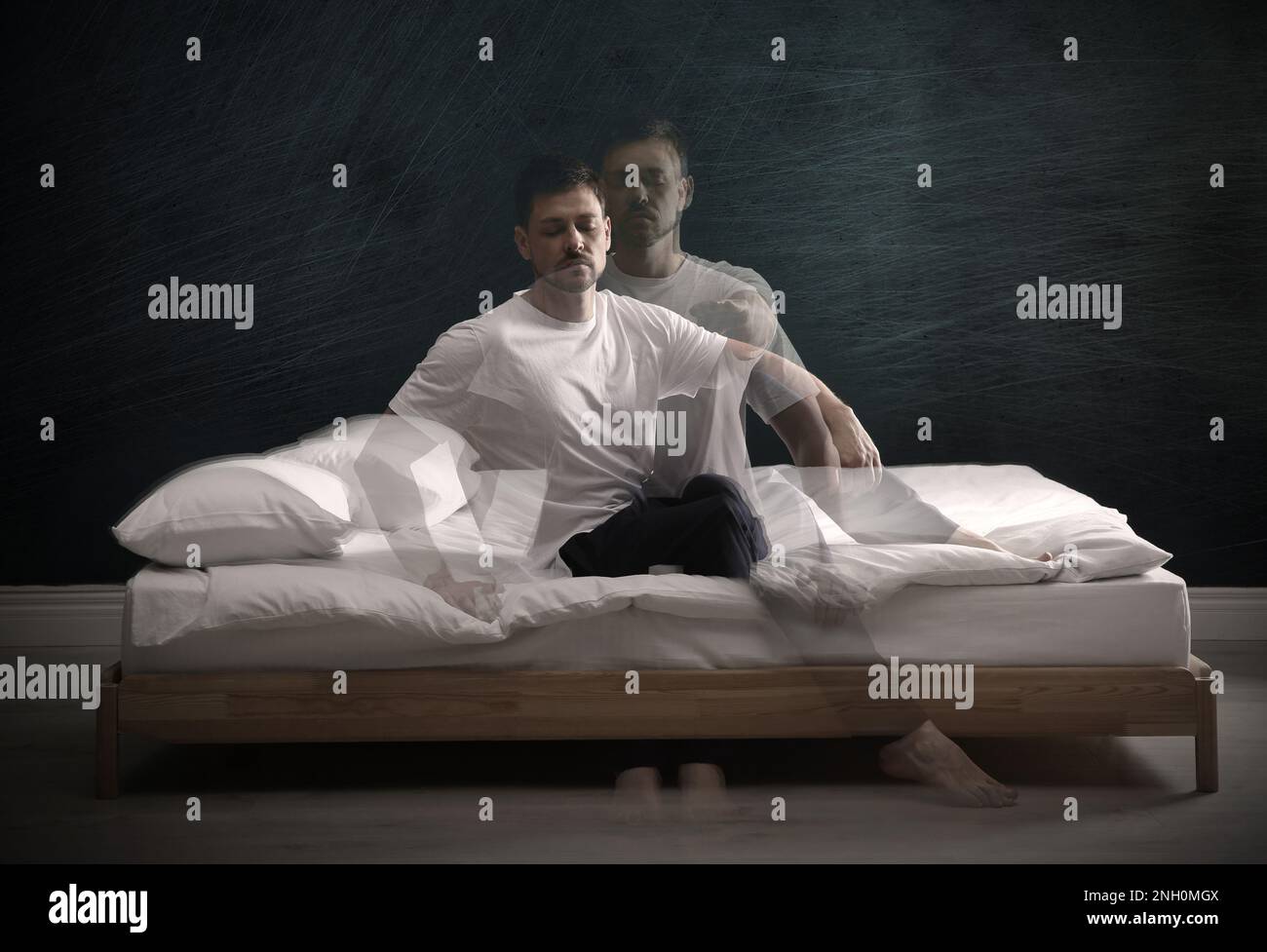 Somnambulist rising from bed near dark wall indoors, multiple exposure ...