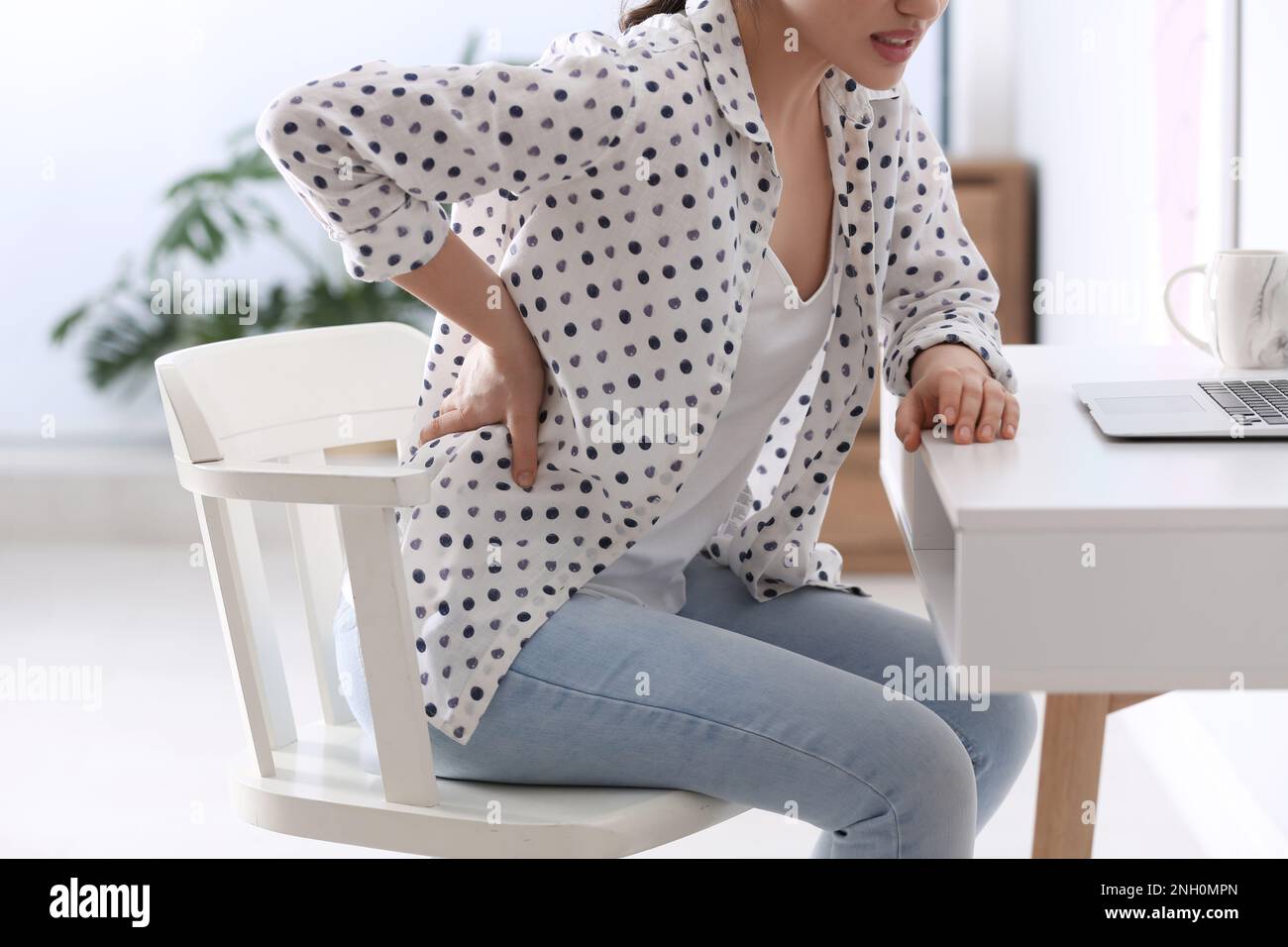 Woman suffering from back pain in office, closeup. Bad posture problem ...