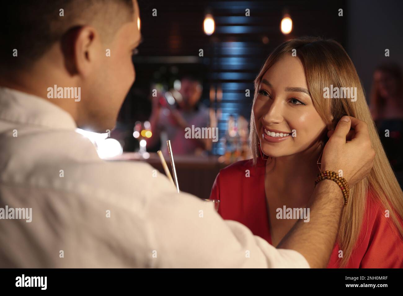 Man and woman flirting with each other in bar Stock Photo - Alamy