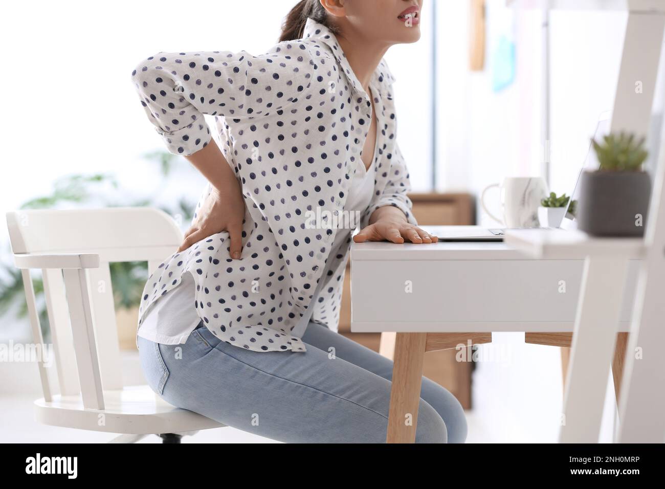Woman suffering from back pain in office, closeup. Bad posture problem ...