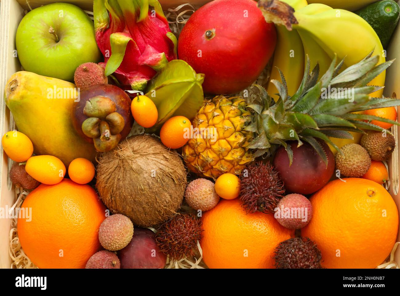 Assortment of exotic fruits in wooden crate, top view Stock Photo - Alamy