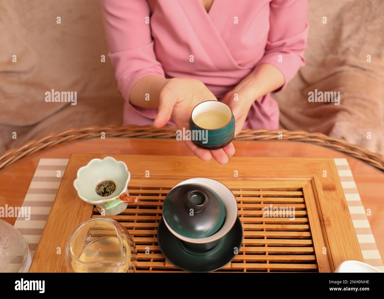 Master offering cup of freshly brewed tea during traditional ceremony ...