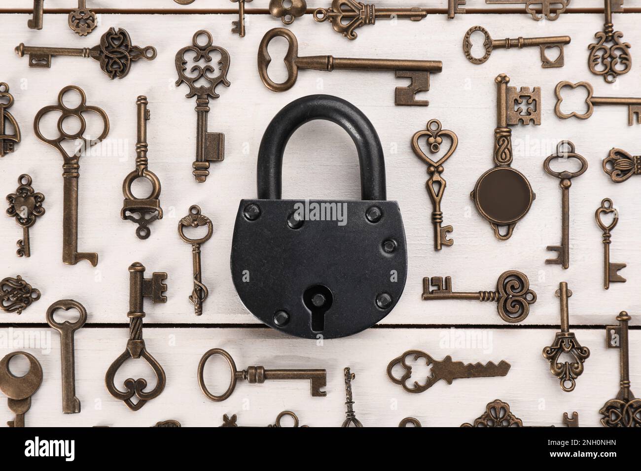 Flat lay composition with padlock and beautiful vintage keys on white ...