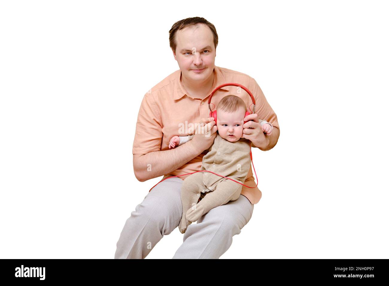 Man father and boy son listen to music on headphones on sofa in home ...