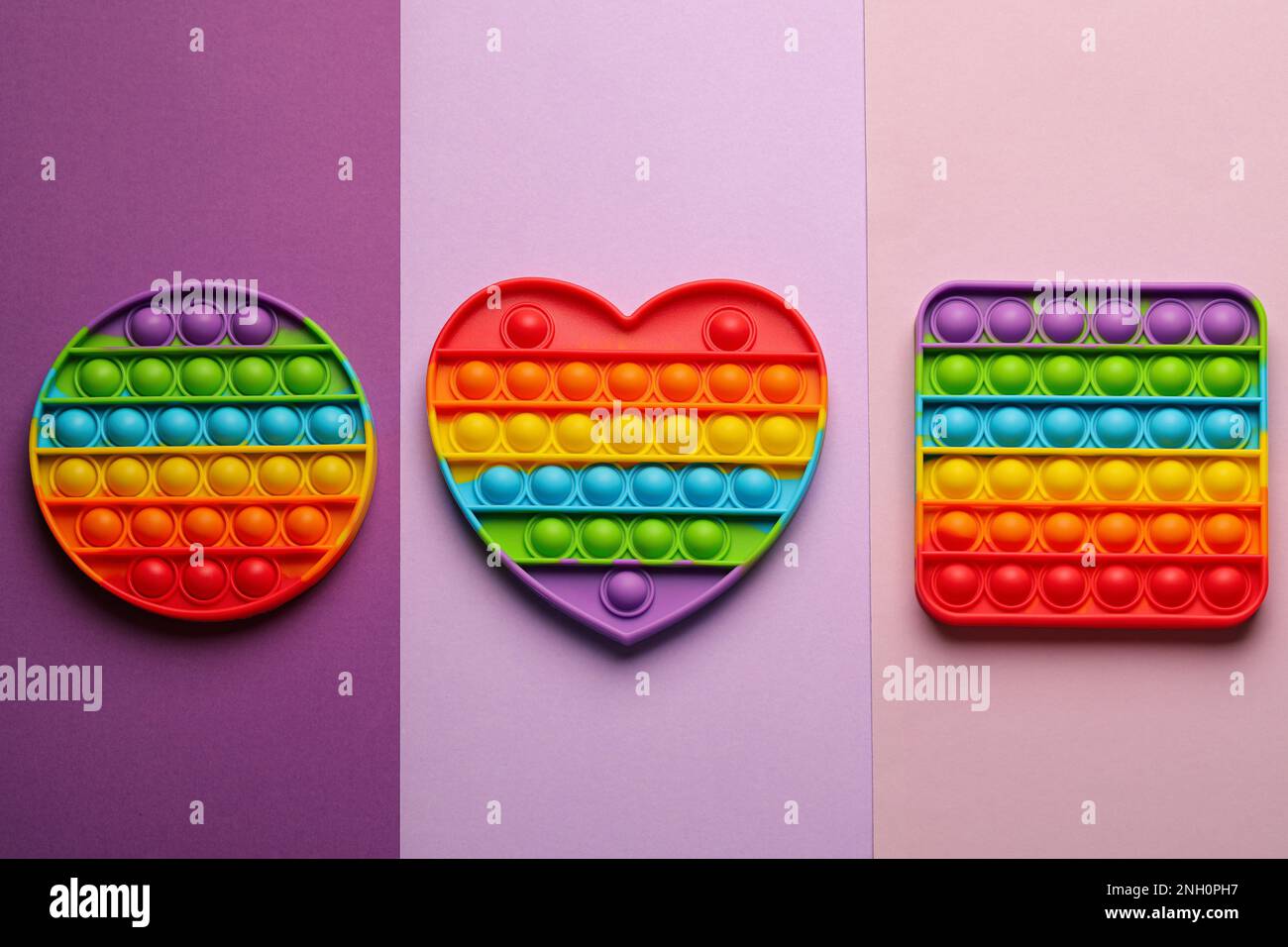 Rainbow pop it fidget toys on color background, flat lay Stock Photo ...