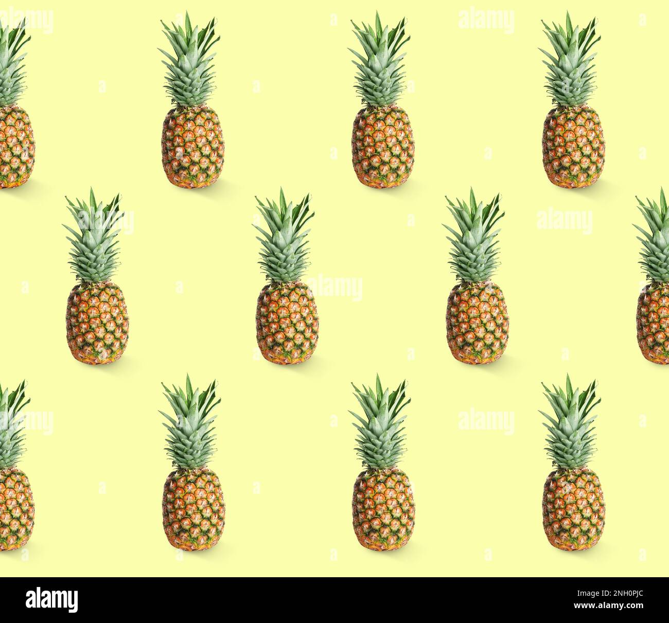 Delicious ripe pineapples on yellow background. Exotic fruits Stock ...