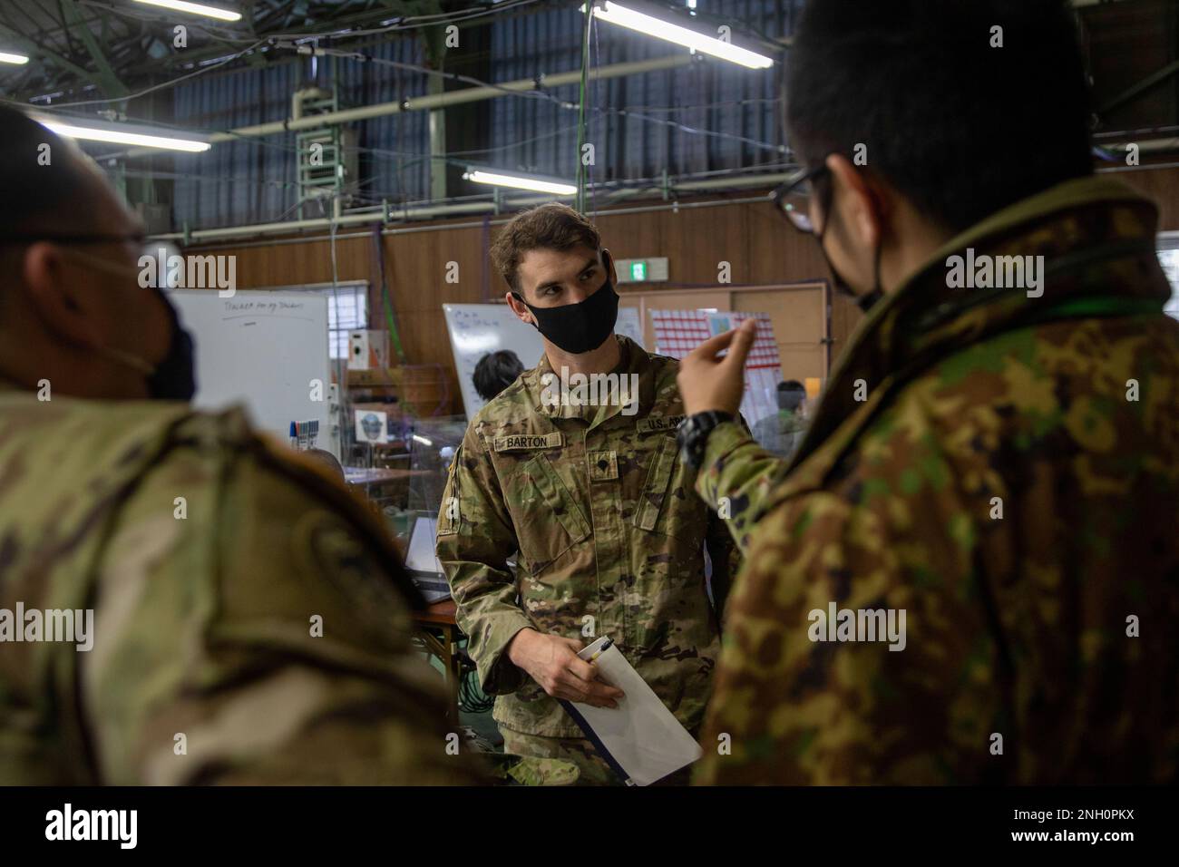 Soldiers assigned to 1st Brigade 11th Airborne Division, discuss plans ...
