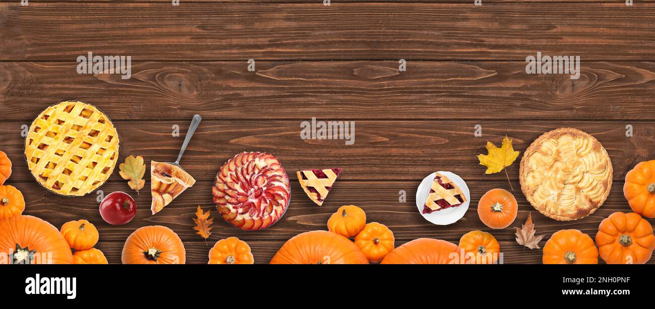 Flat lay composition with different tasty pies on wooden table. Banner ...