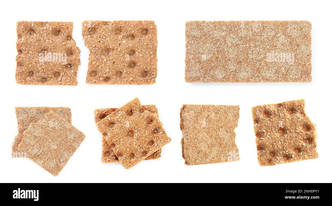 Set with fresh crunchy rye crispbreads on white background, top view ...