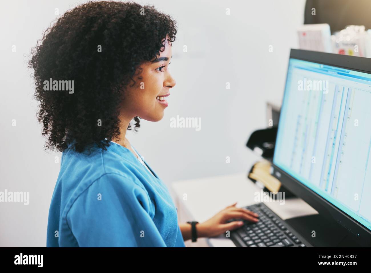 Nurse, computer and black woman typing for research in healthcare ...
