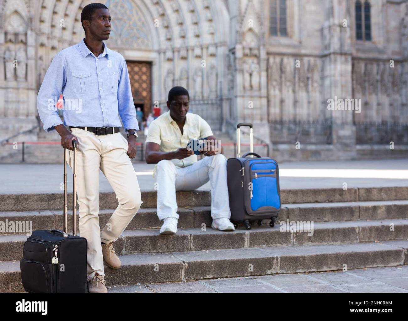 African-american tourists taking walk in the town with the travel bag ...