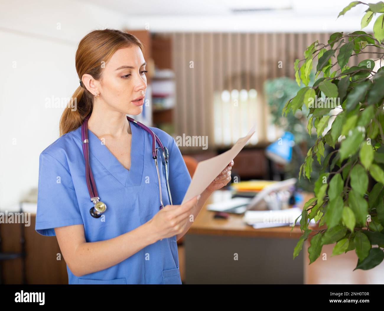 Female doctor reviewing medical history of patient in office Stock ...