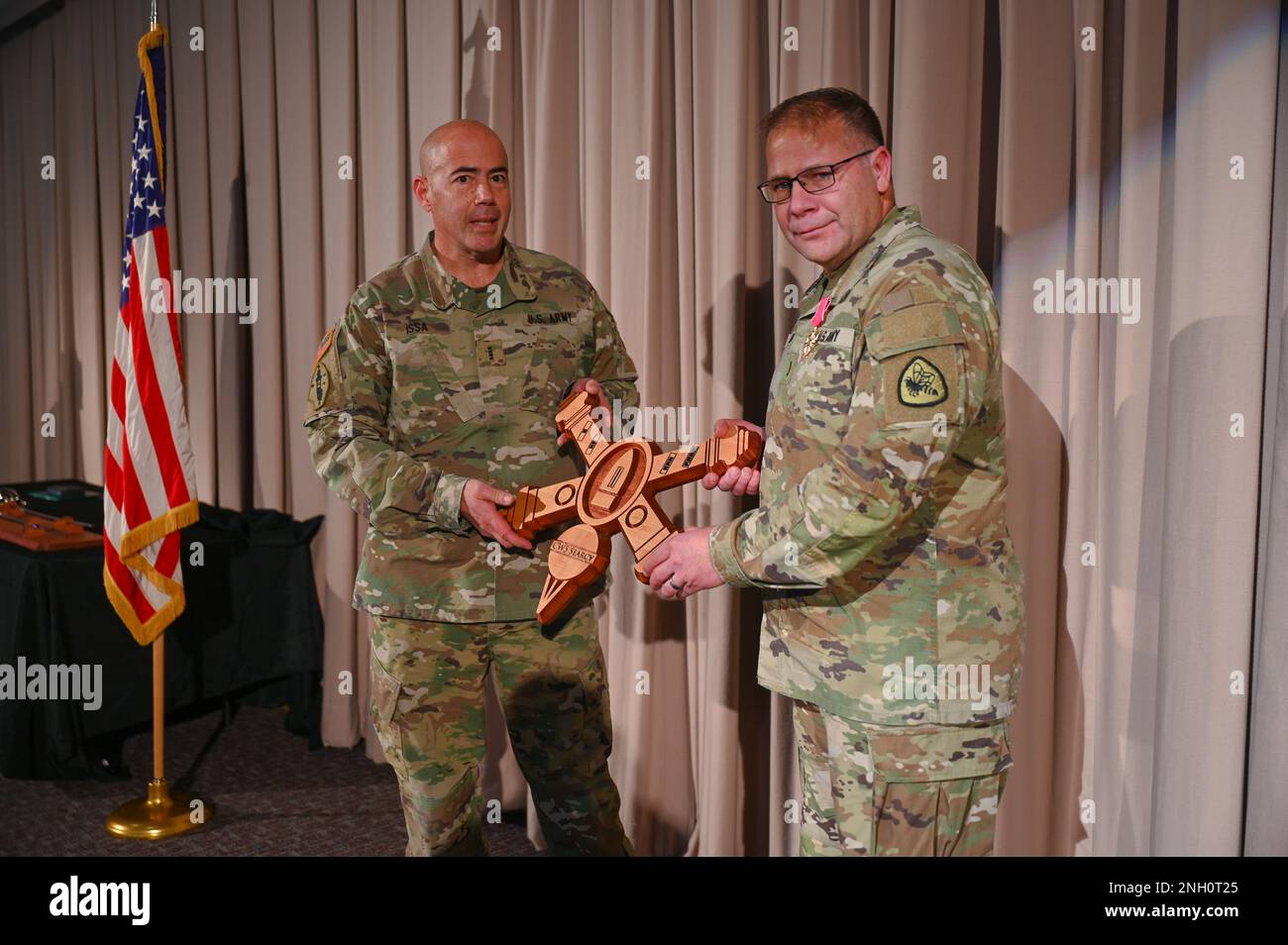 Command Chief Warrant Officer 5 Brian Searcy (right) is given a ...