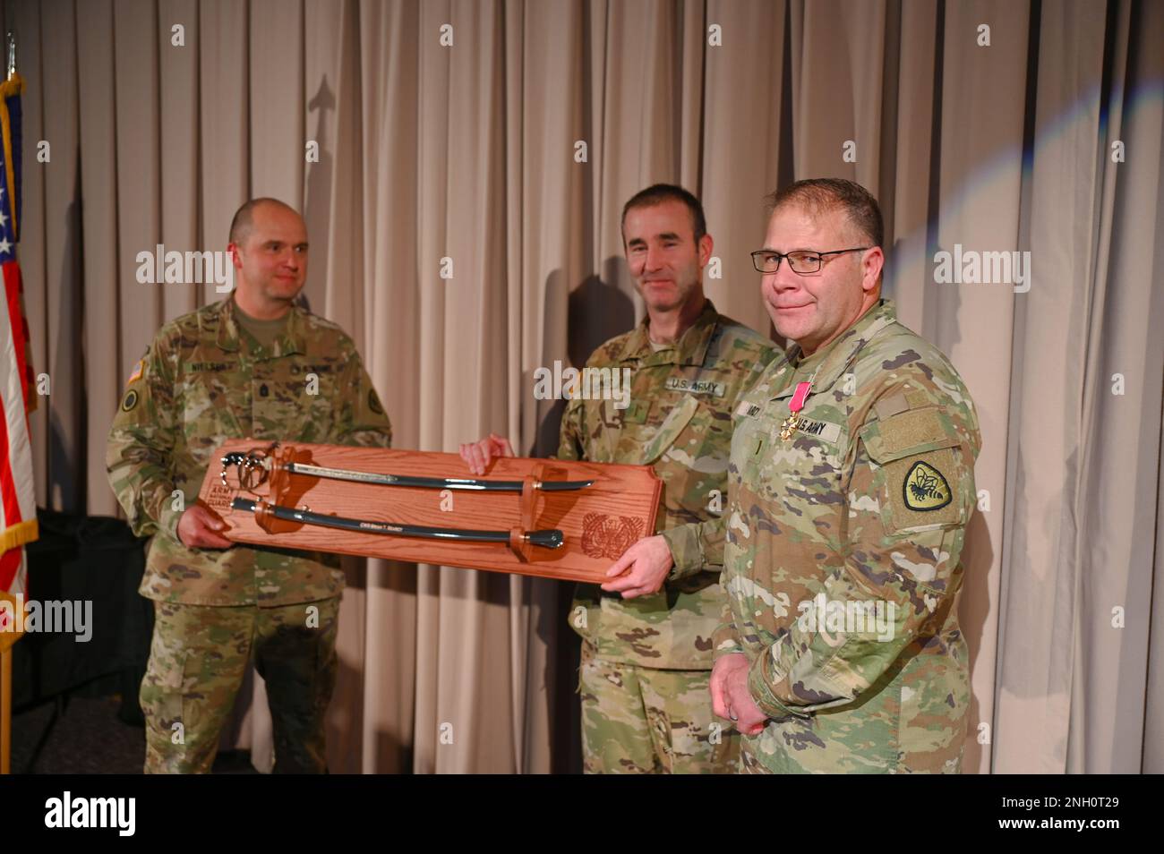 Command Chief Warrant Officer 5 Brian Searcy (right) is given a ...