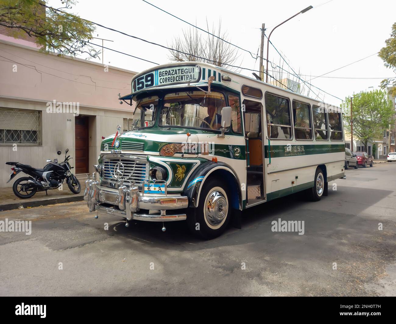 Old white 1980s Mercedes Benz 911 bus in the street. Public passenger ...