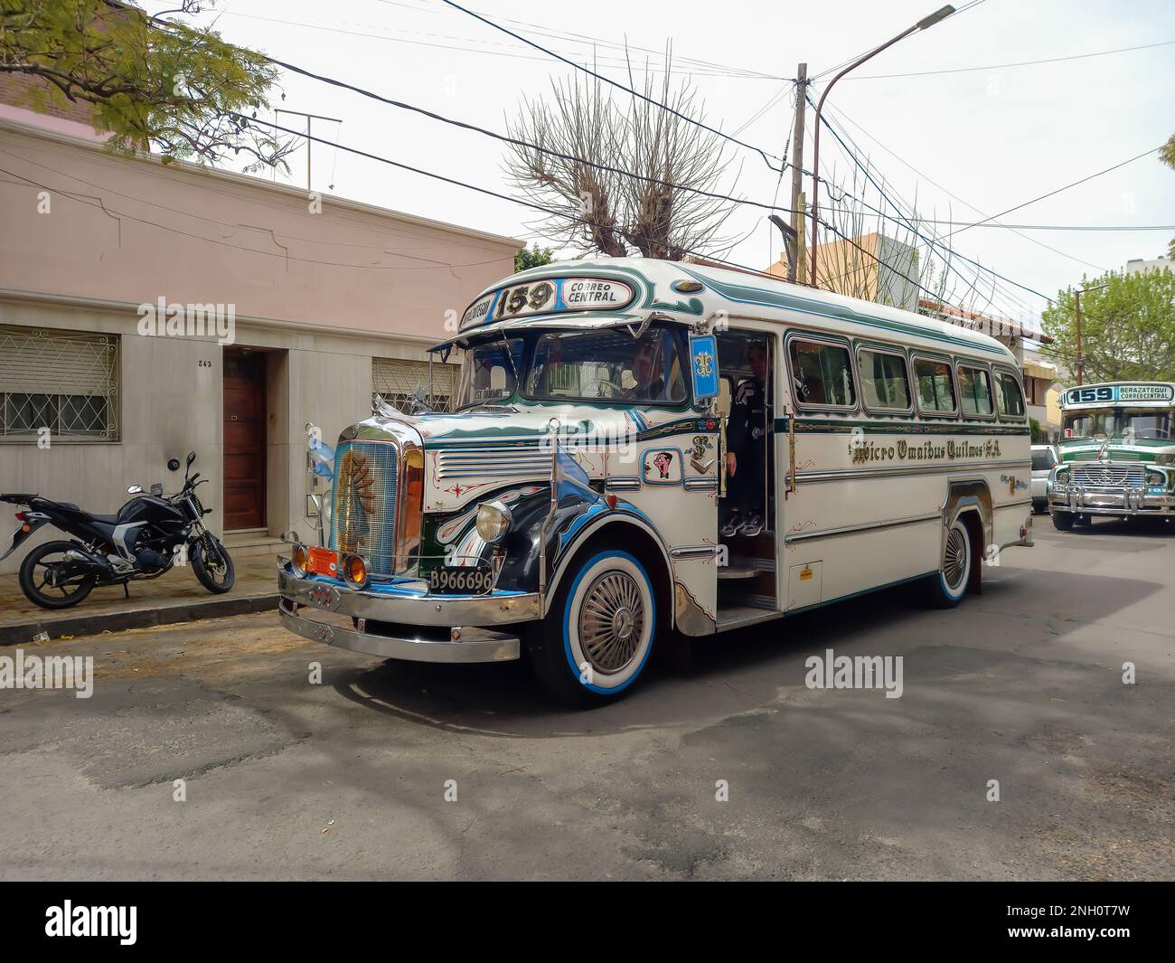 Old white 1970s Mercedes Benz 911 bus in the street. Public passenger ...