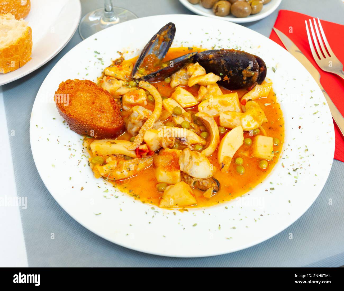 Fried cuttlefish in spicy sauce Stock Photo - Alamy