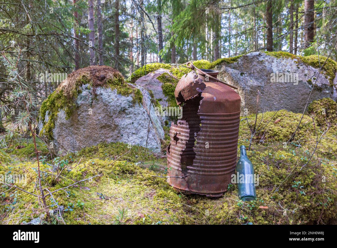 Old rusty barrel and a glass bottle in the forest Stock Photo - Alamy