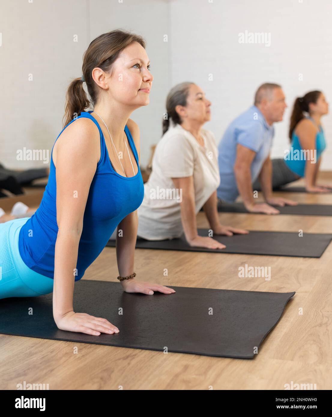 Woman performing back bending asana Urdhva Mukha Shvanasana Stock Photo ...