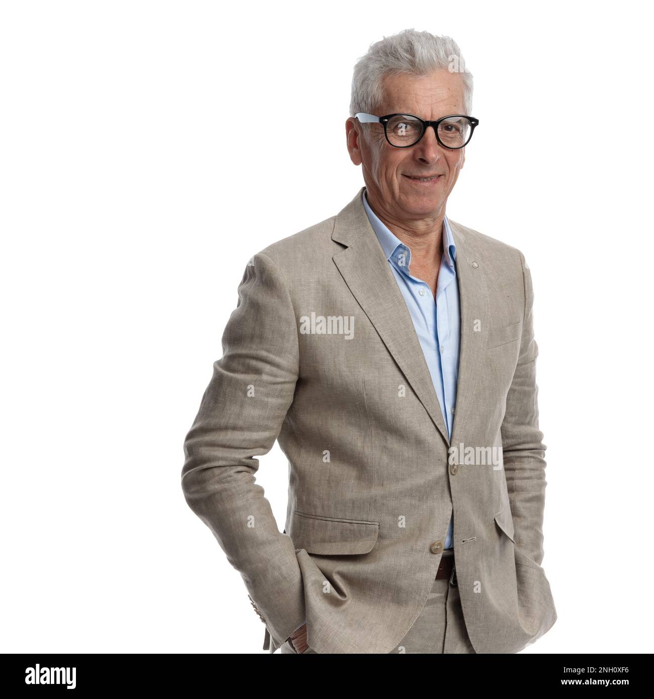 elegant man wearing beig esuit with open collar shirt holding hands in ...