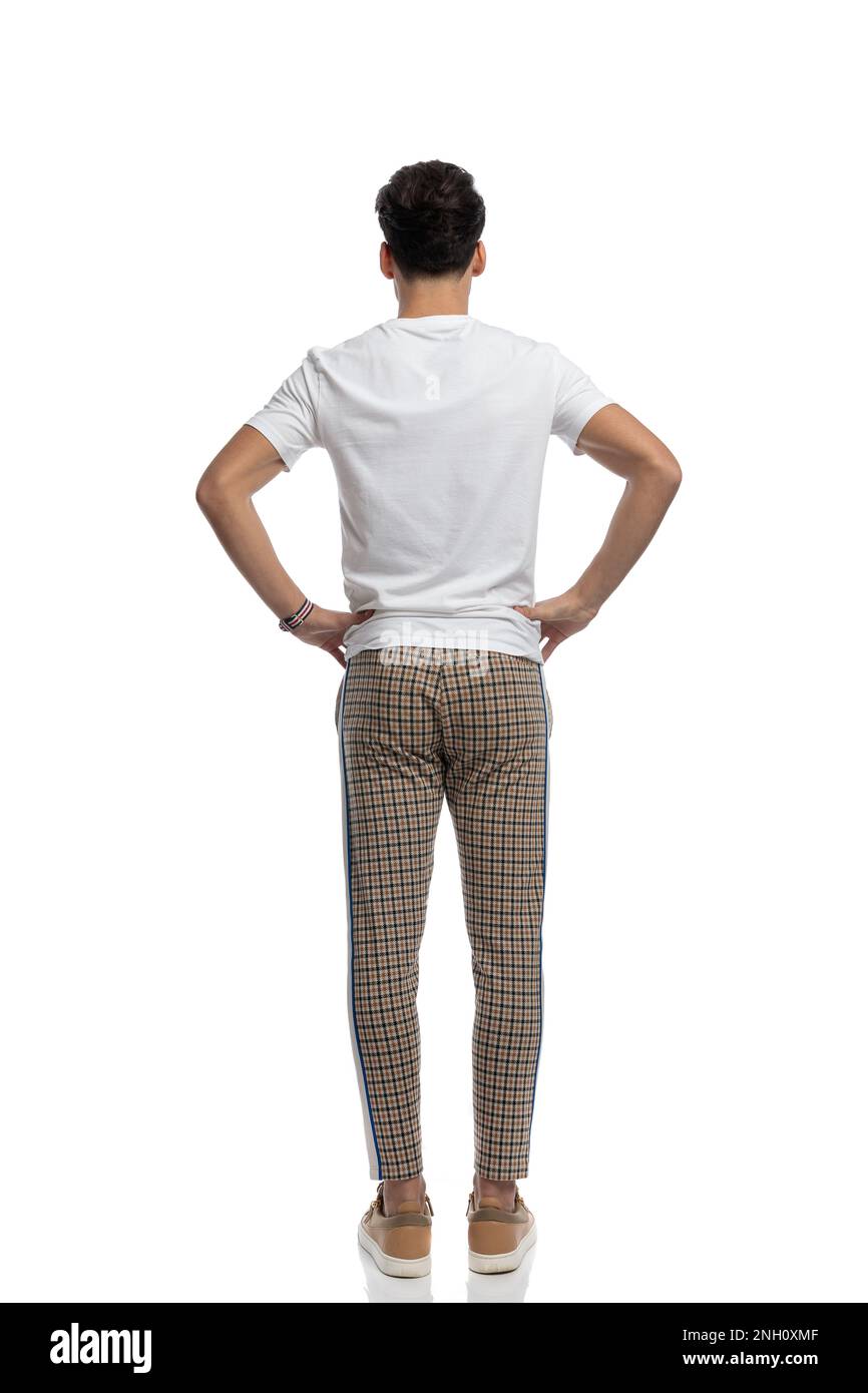 behind view of casual man with plaid pants and white t-shirt posing ...