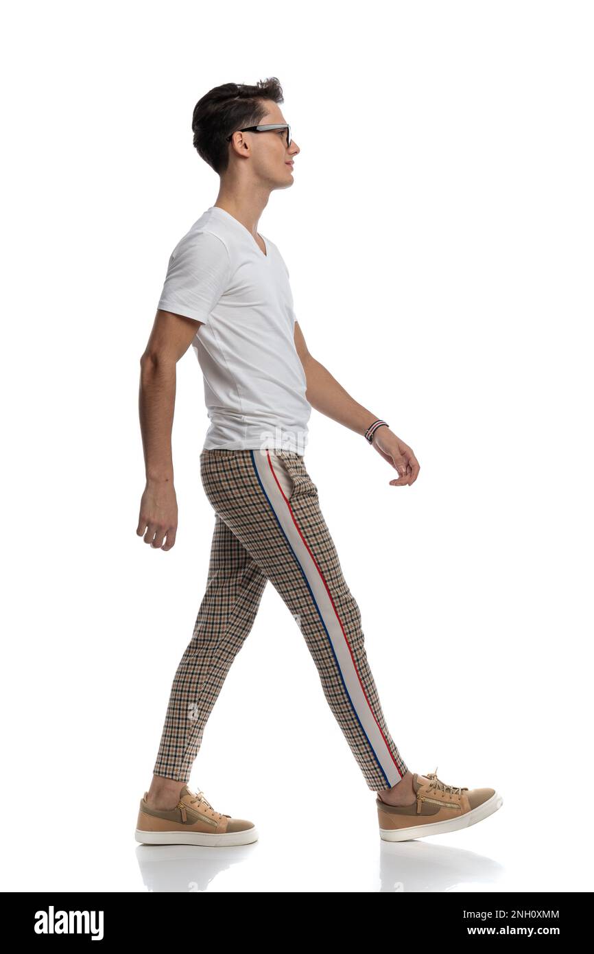 side view picture of cool brunette guy with glasses smiling and walking ...