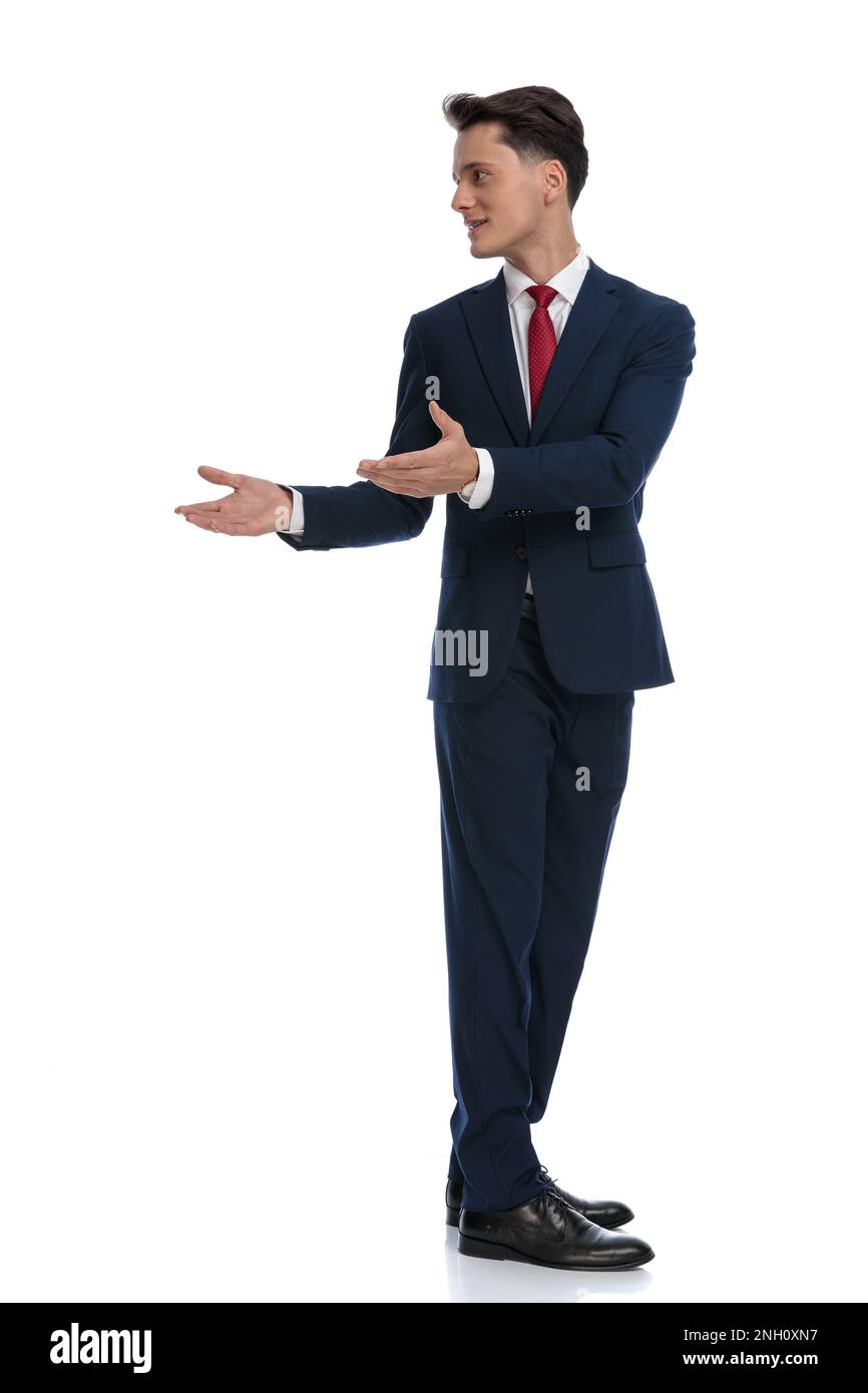 handsome businessman turning back and greeting someone, wearing a suit ...