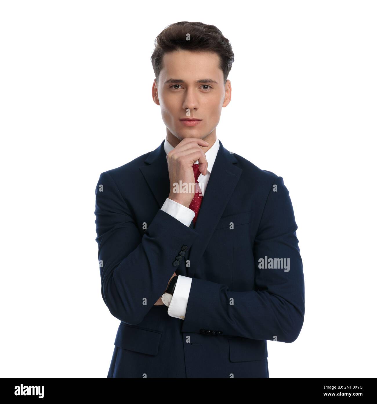 elegant businessman crossing his arms and scratching his chin, wearing ...