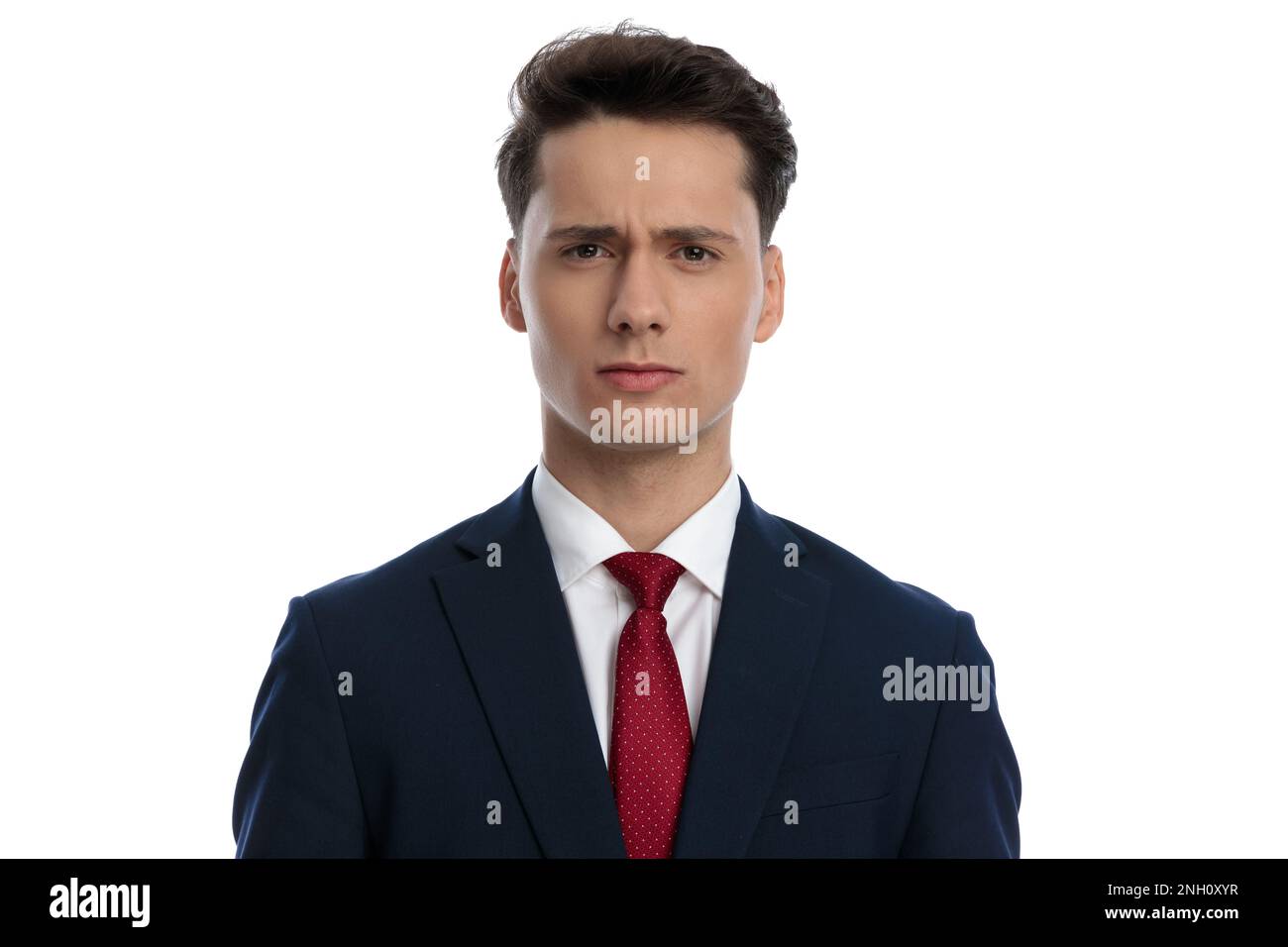 attractive businessman posing with a tough look on his face, wearing a ...