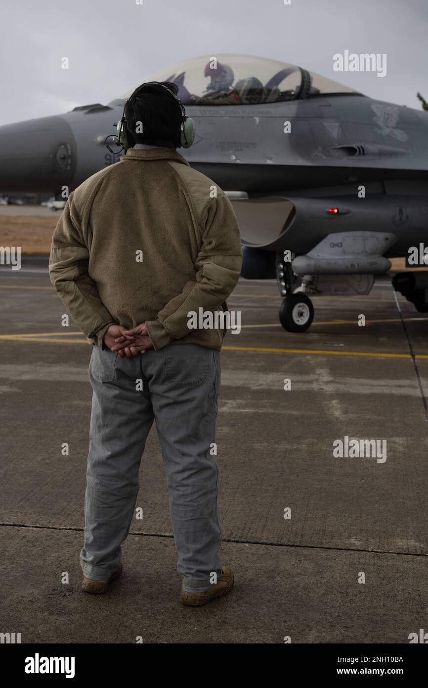 A U.S. Air Force Airman from the 13th Fighter Squadron stands by as Lt ...