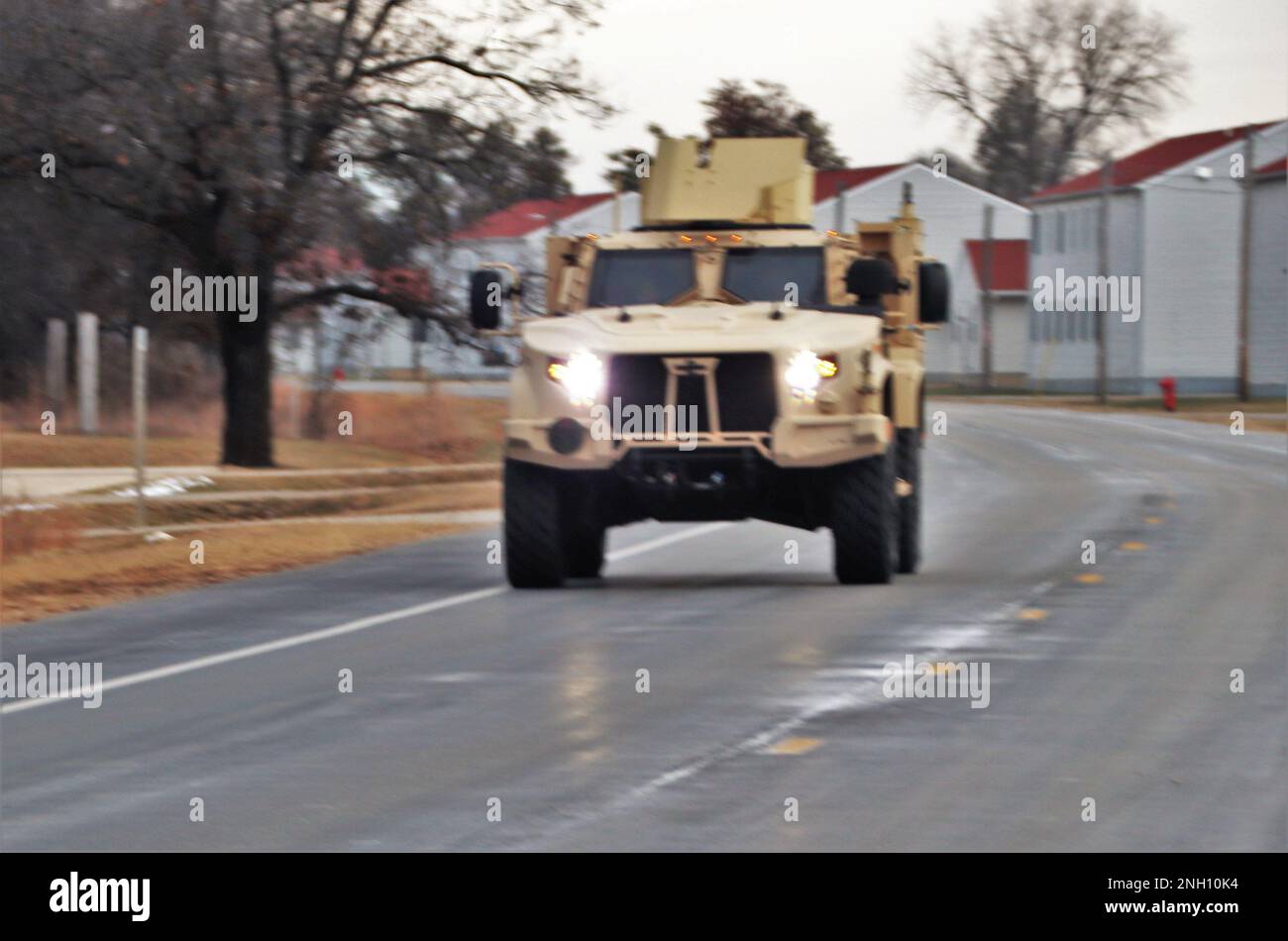 Personnel drive a Joint Light Tactical Vehicle (JLTV) through the ...
