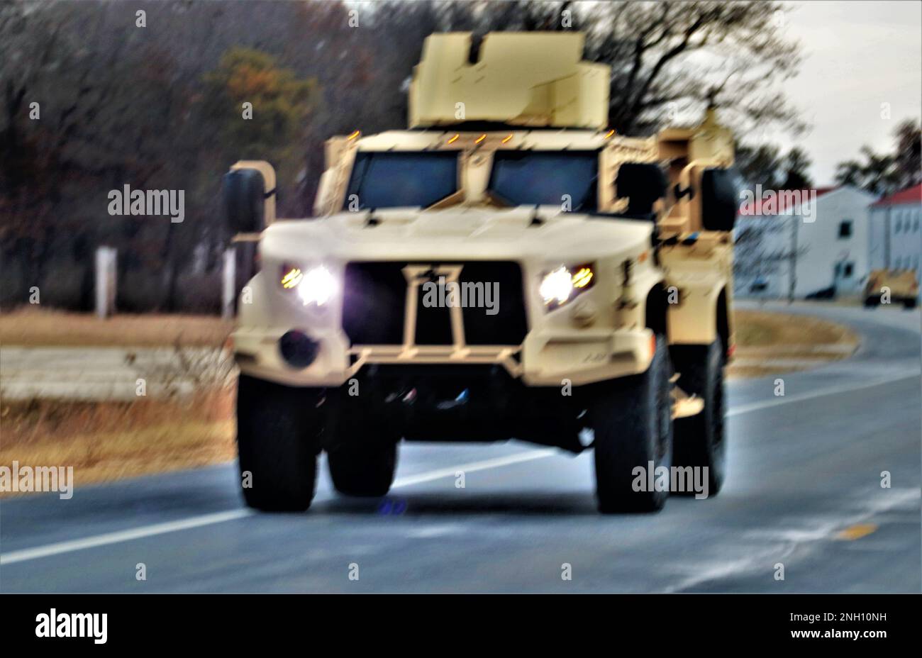 Personnel drive a Joint Light Tactical Vehicle (JLTV) through the ...