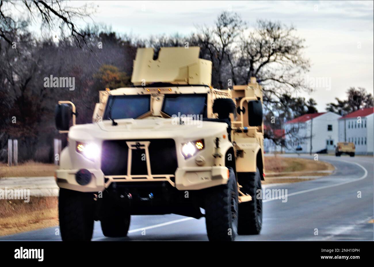 Personnel drive a Joint Light Tactical Vehicle (JLTV) through the ...