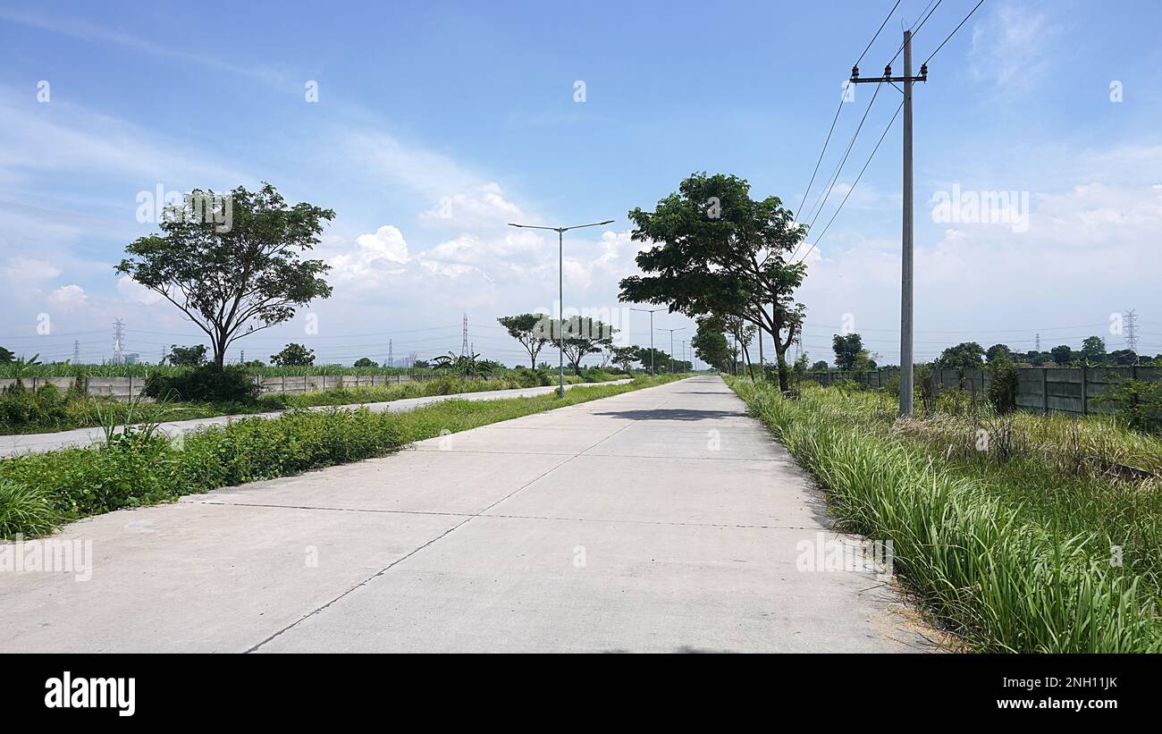 a quiet empty village rural road with a tranquil and cool natural feel ...