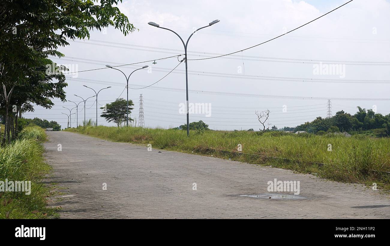 a quiet empty village rural road with a tranquil and cool natural feel ...