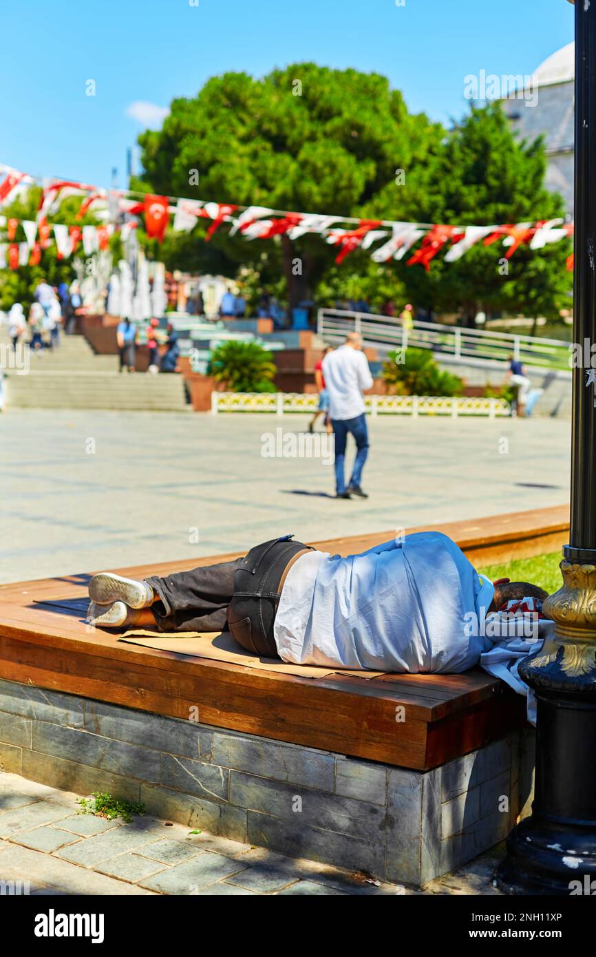 A homeless man sleeps on a bench in Sutan Ahmed Square in Istanbul ...