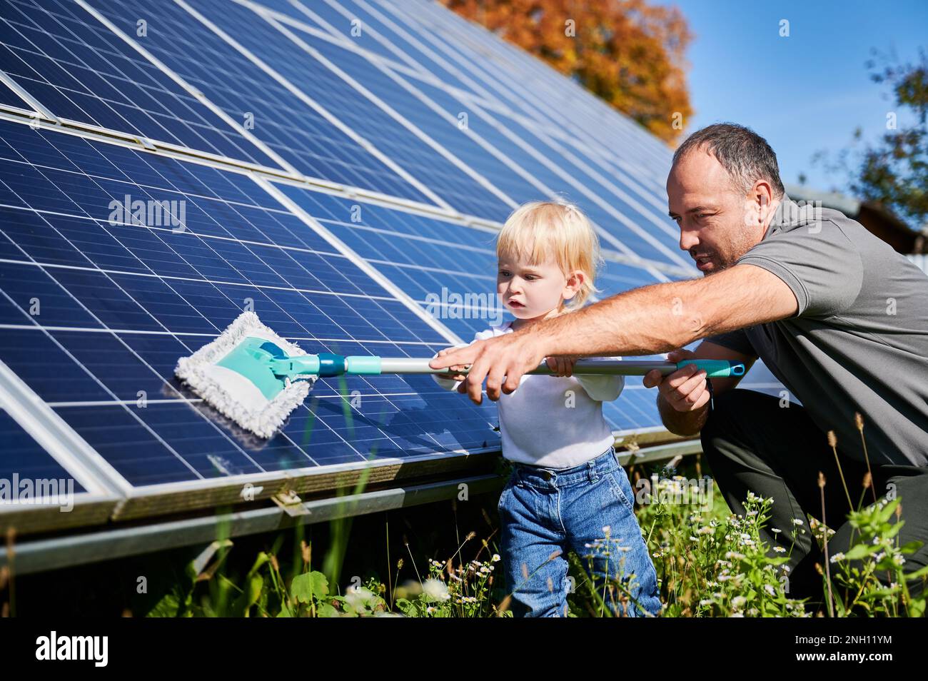 Father showing his little son the solar panels during sunny day. Cute ...