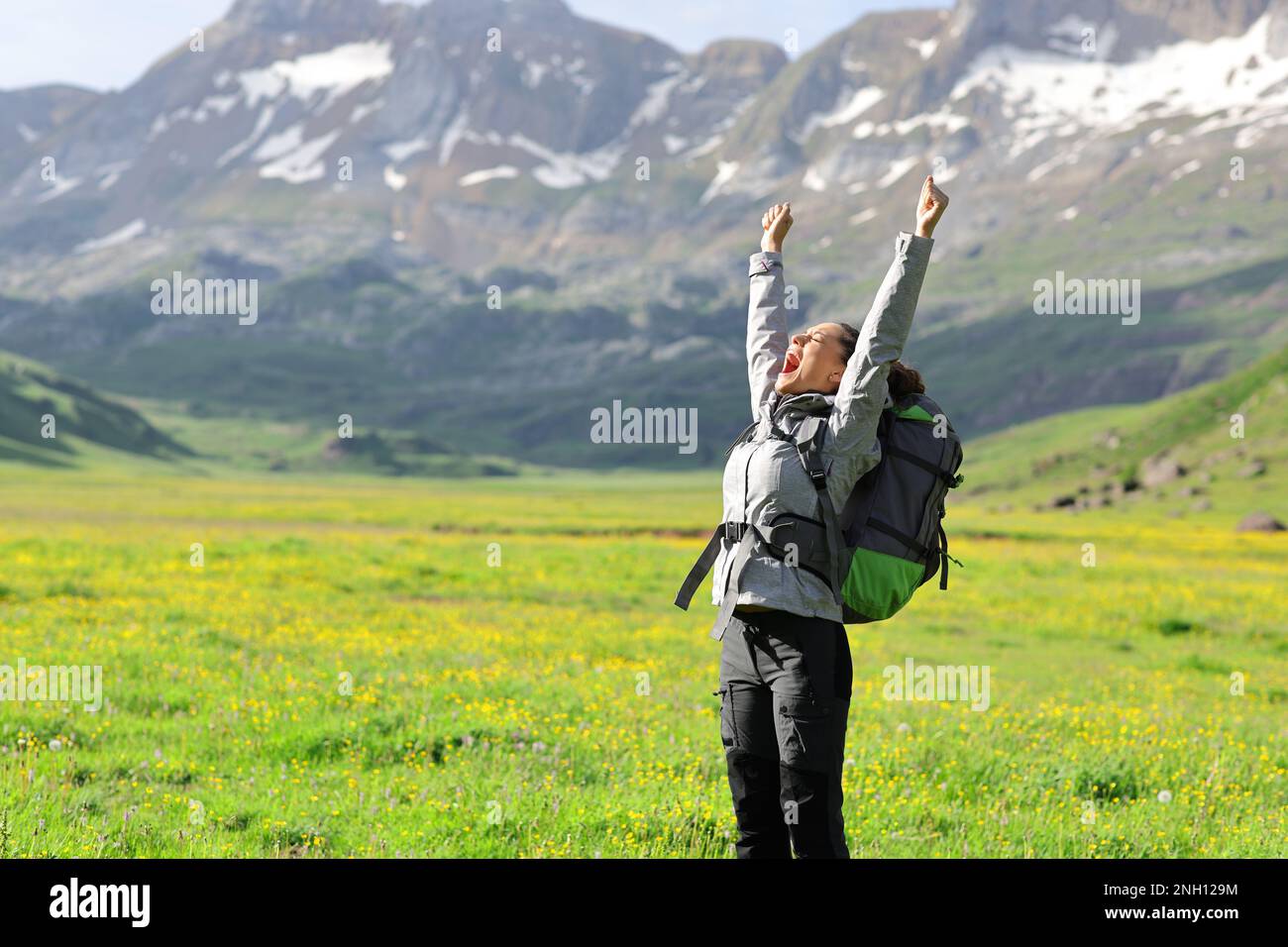 Happy hiker raising arms and screaming celebrating vacation in nature ...