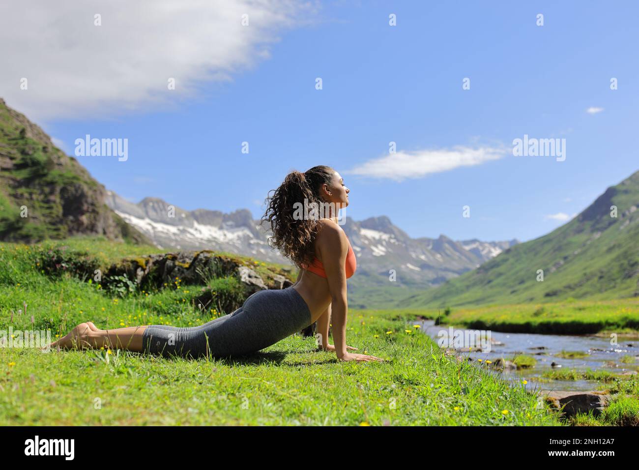 Full body side view portrait of a yogi doing yoga exercise in a ...